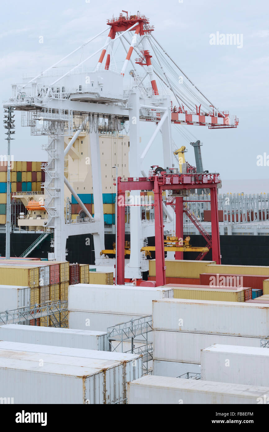 Large harbor crane loading containers on a a large cargo vessel Stock ...