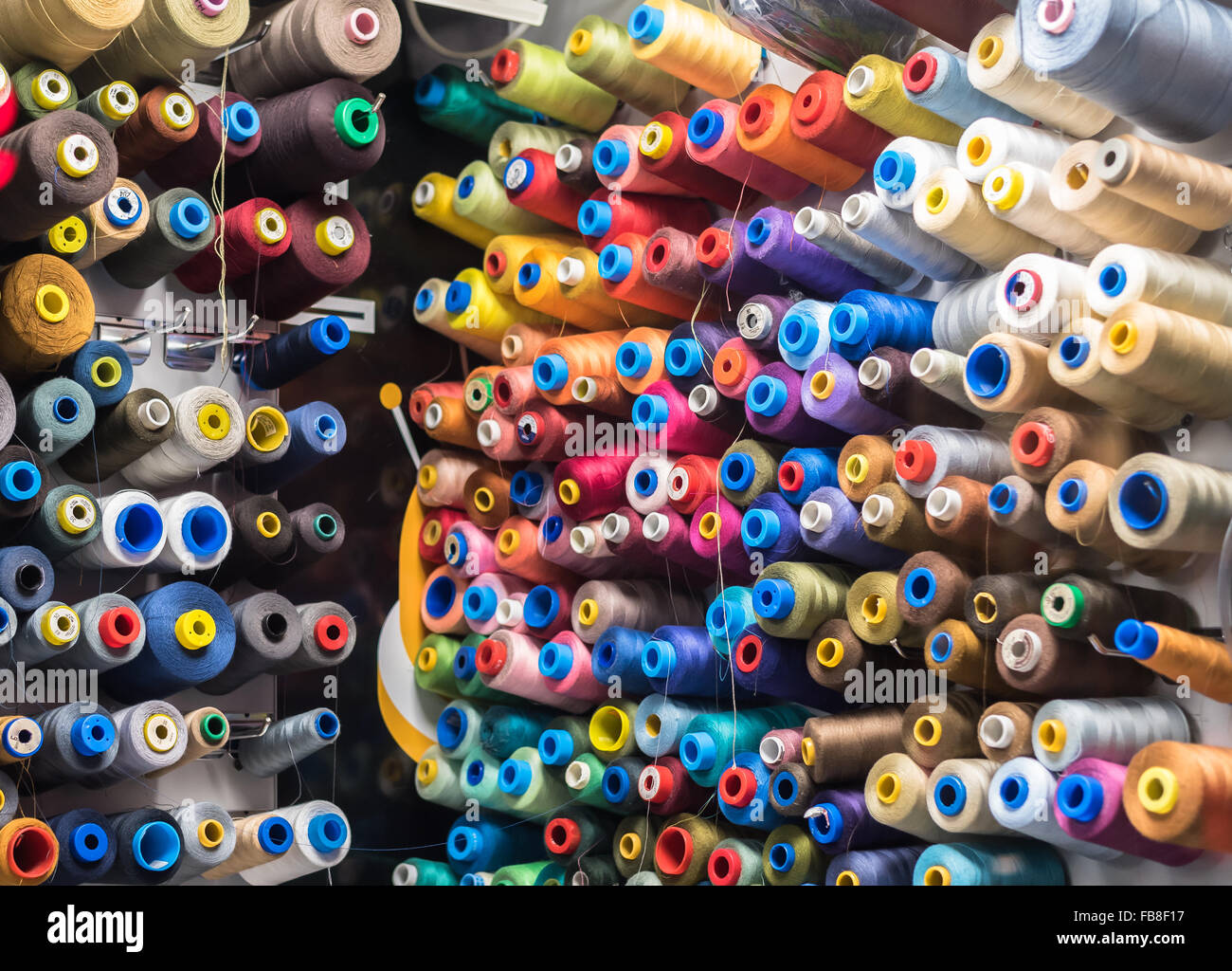 Many colorful cotton reels background Stock Photo - Alamy