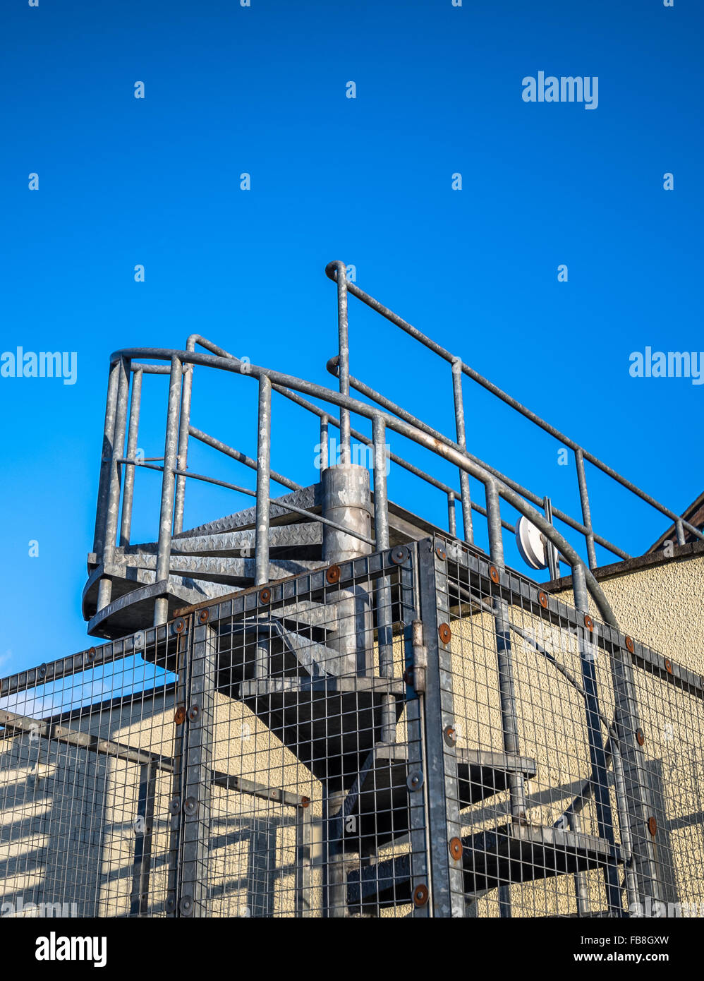 Metal spiral fire escape and cage Stock Photo - Alamy