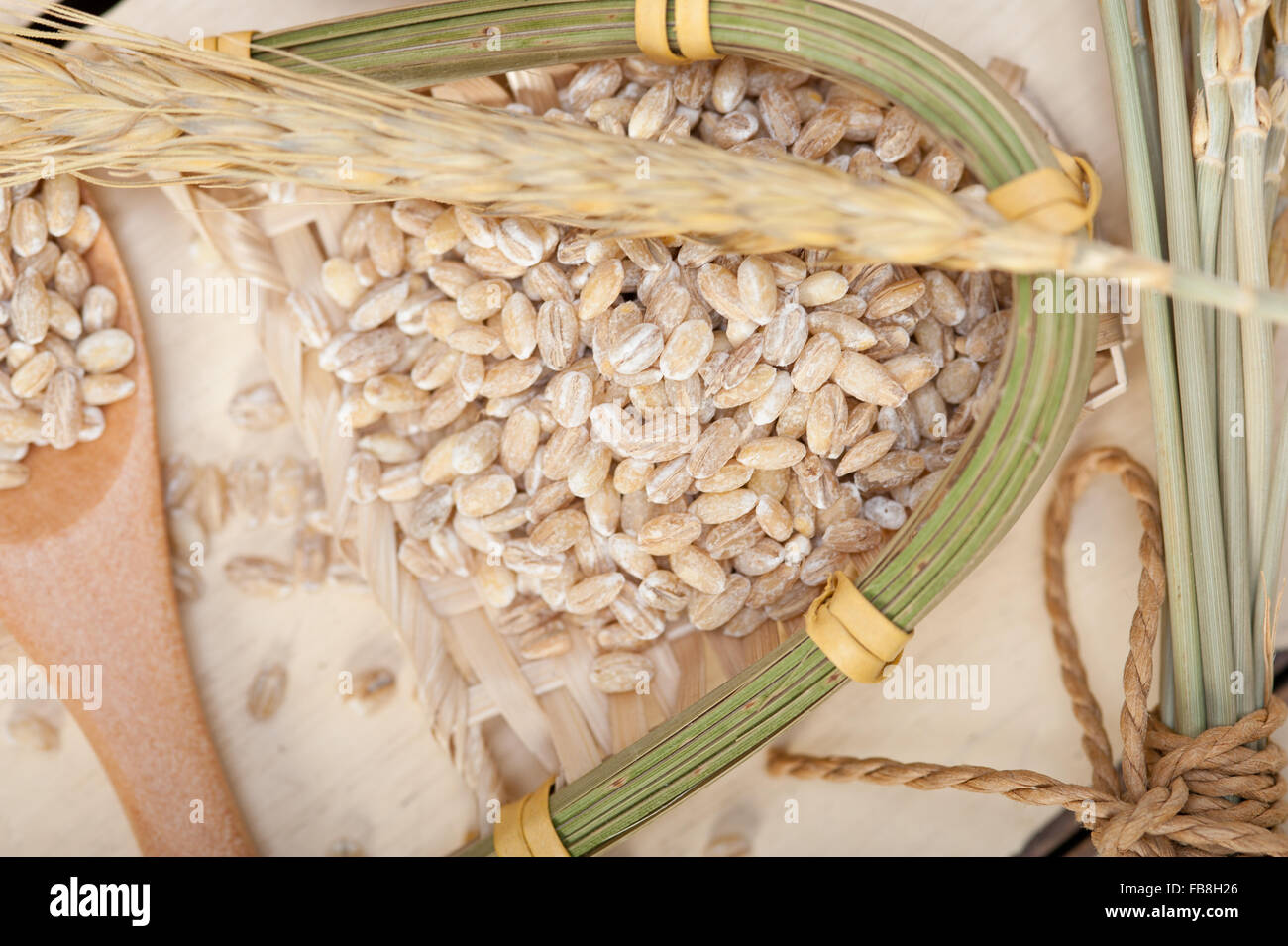 organic wheat grains over rustic wood table macro closeup Stock Photo ...