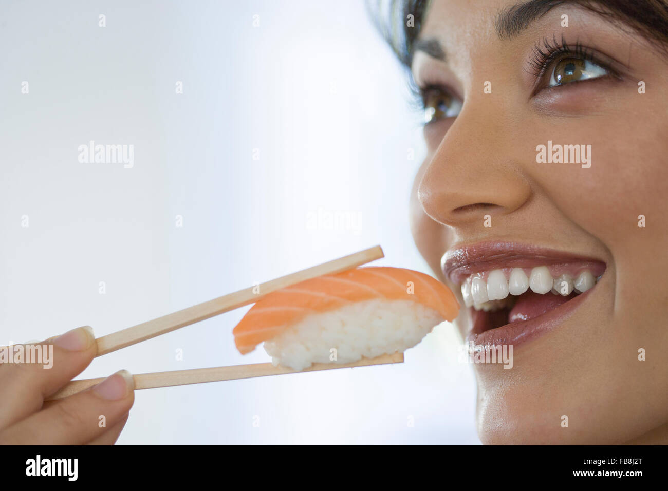 Young woman eating sushi, closeup Stock Photo - Alamy