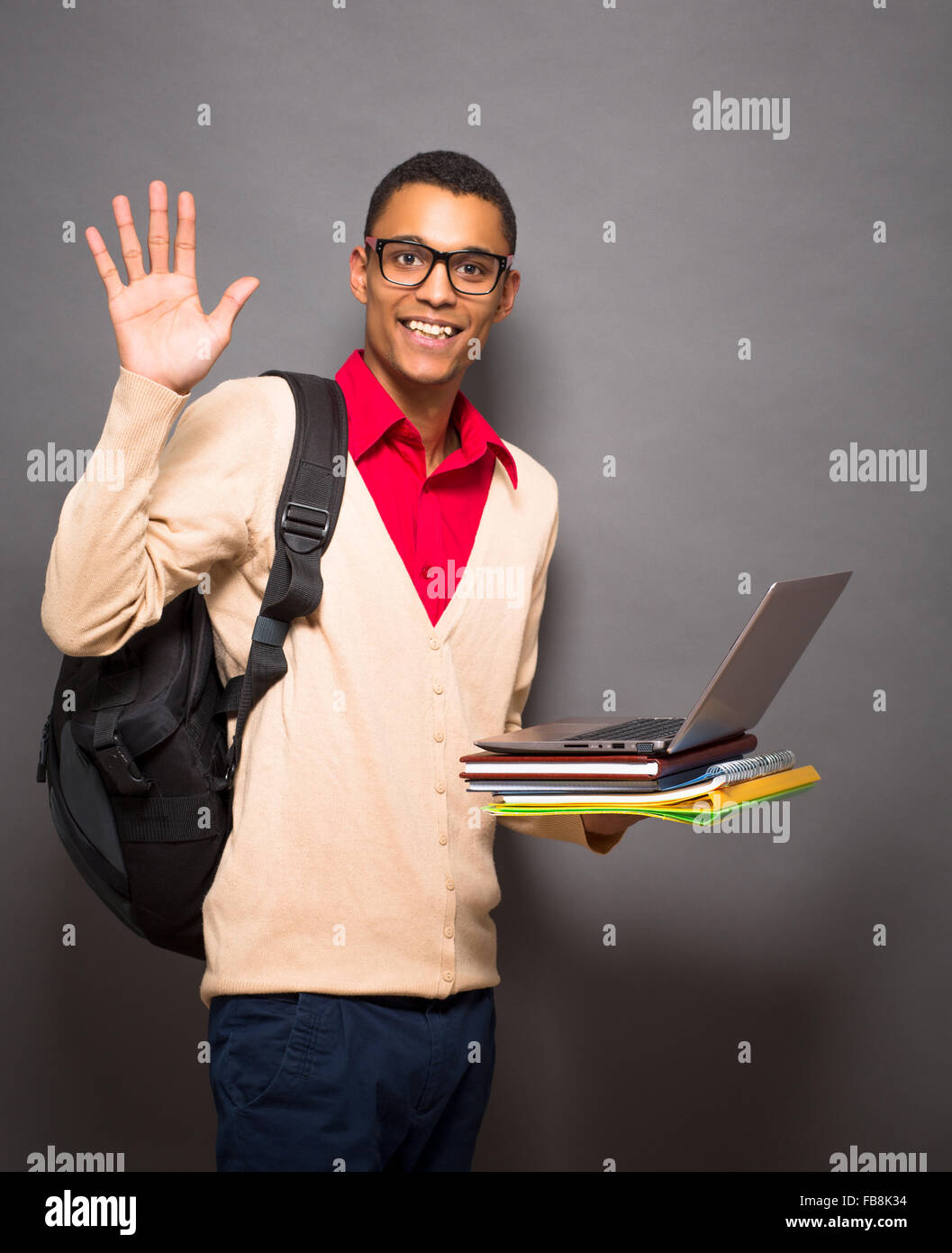 Handsome latin student with laptop computer in studio Stock Photo - Alamy