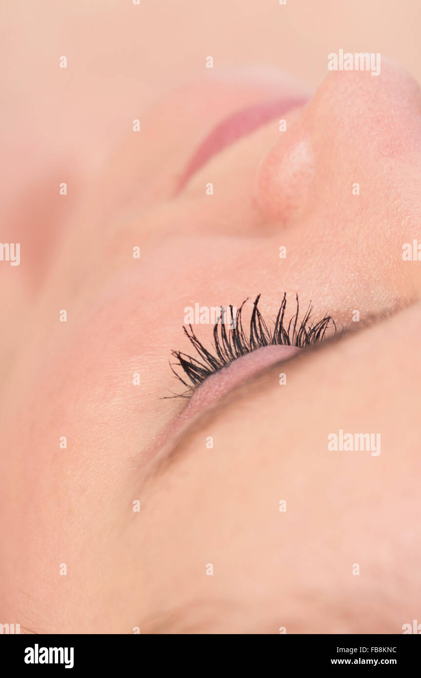 Close up of a woman lying down eyes closed Stock Photo - Alamy