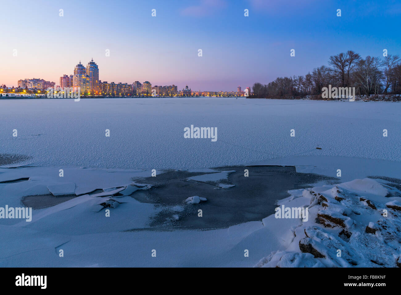 Cold Winter night cityscape with illuminated buildings in Kiev, Ukraine ...