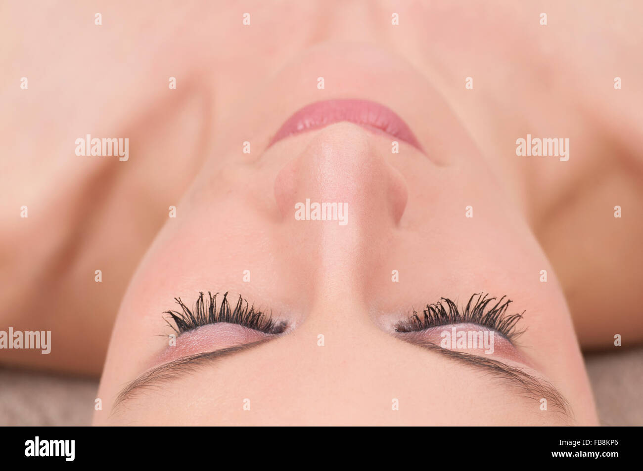 Close up of a woman lying down eyes closed Stock Photo - Alamy