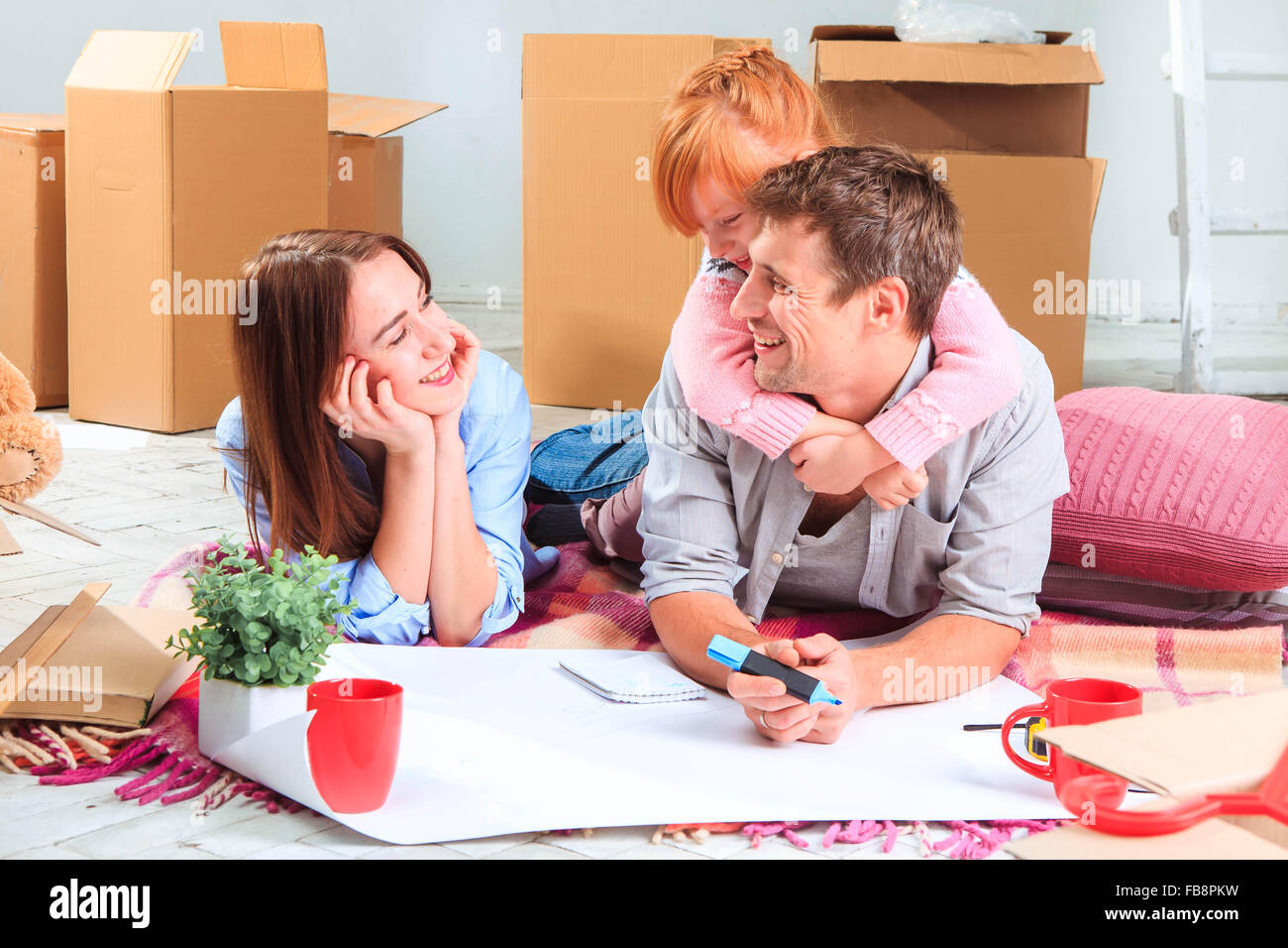 The happy family during repair and relocation Stock Photo - Alamy
