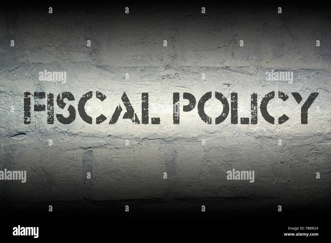 fiscal policy stencil print on the grunge white brick wall Stock Photo ...
