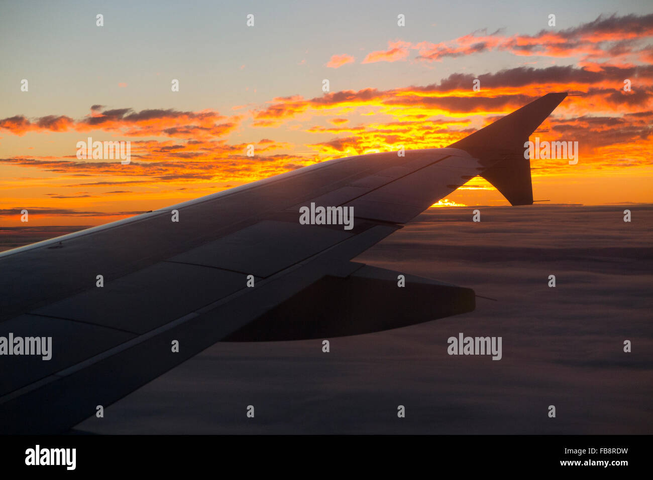 Blue sky with evening sun set / sunset / setting sun and an airplane ...