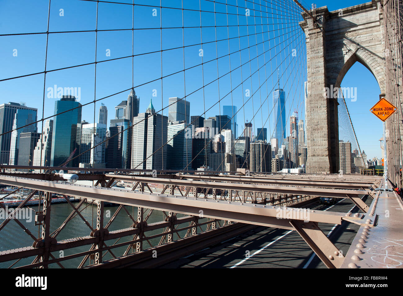 View of one arch of Brooklyn Bridge with the skyline of Downtown ...