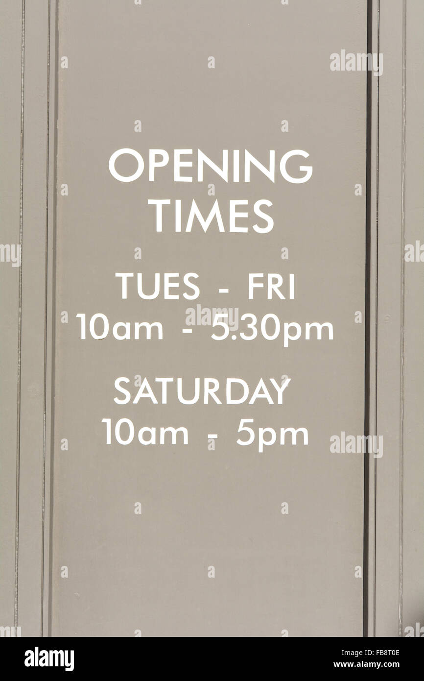 Shop opening times on wall Stock Photo - Alamy