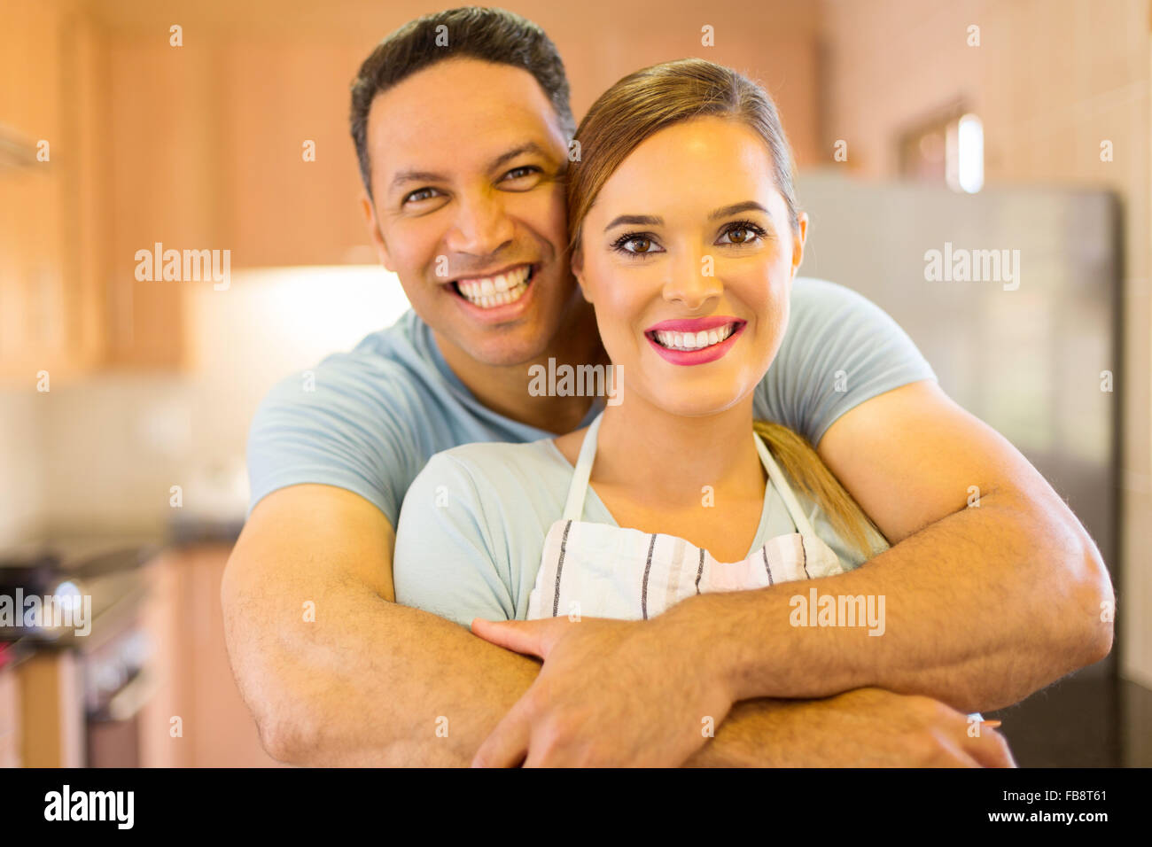 Lovely couple hugging cooking hi-res stock photography and images - Alamy