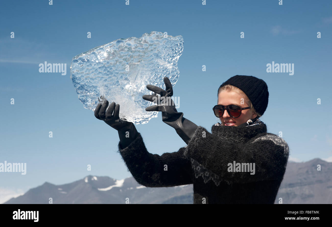Young woman with ice block in hands in icelandic summer Stock Photo - Alamy