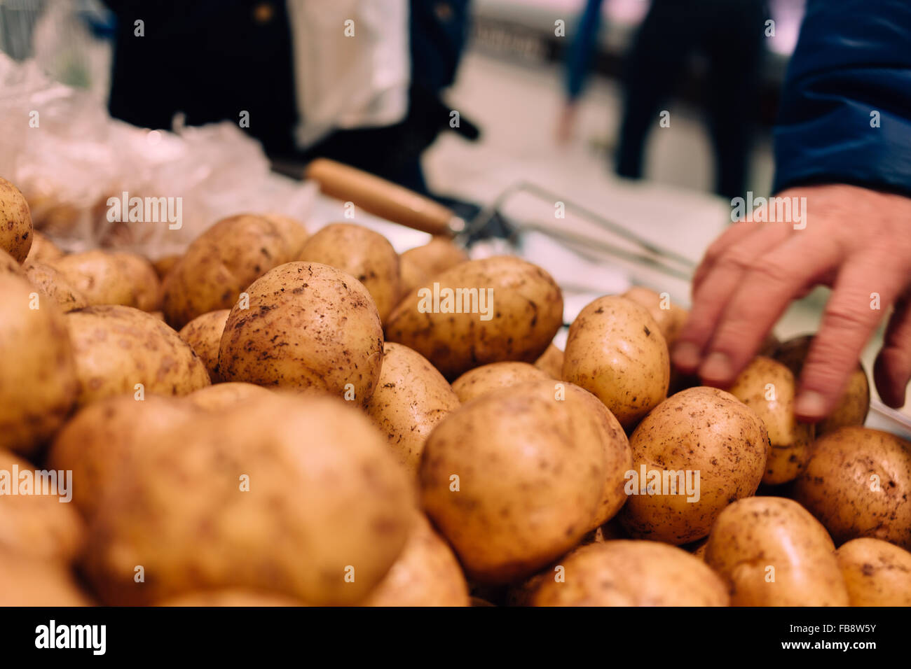 Man potatoes supermarket hi-res stock photography and images - Alamy