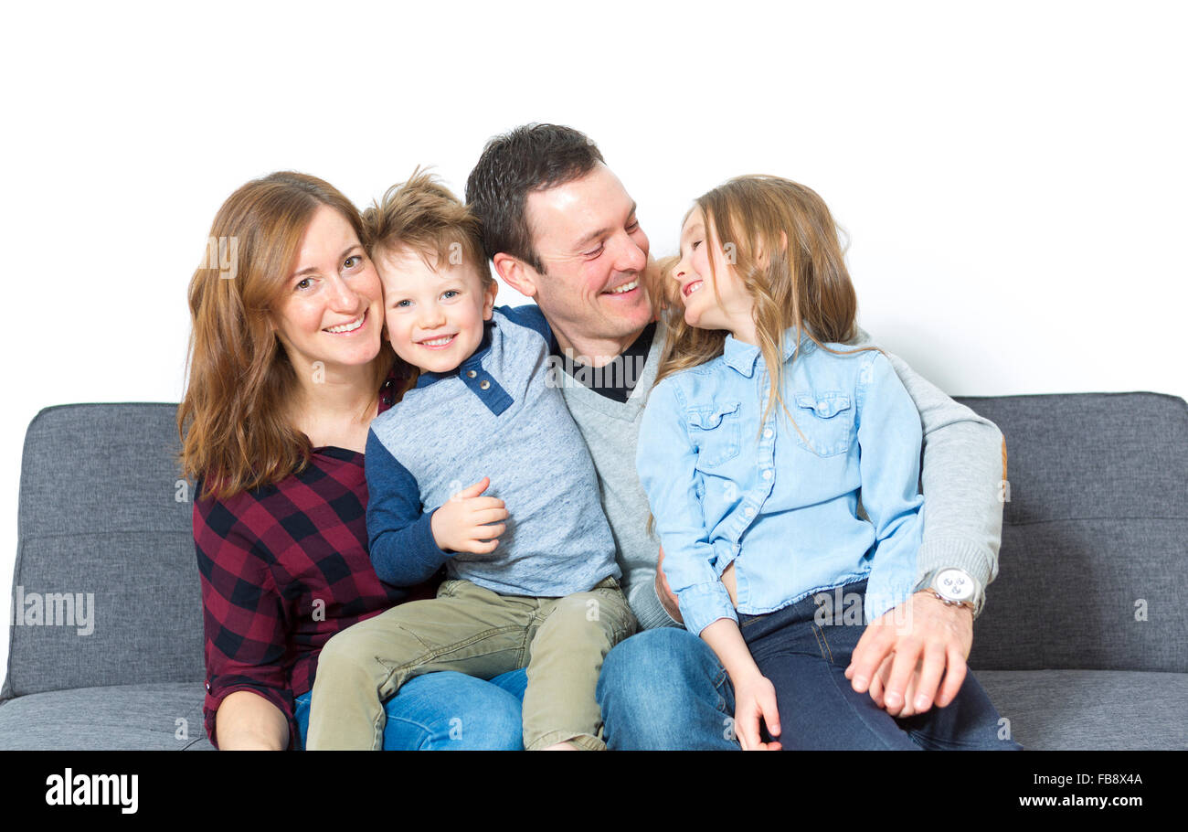 Nice family sit on the livingroom sofa Stock Photo - Alamy