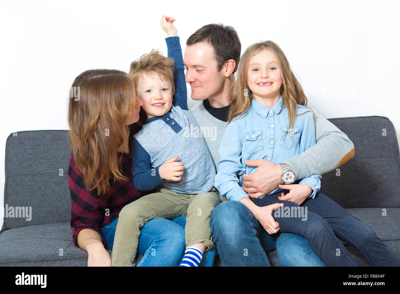 Nice family sit on the livingroom sofa Stock Photo - Alamy