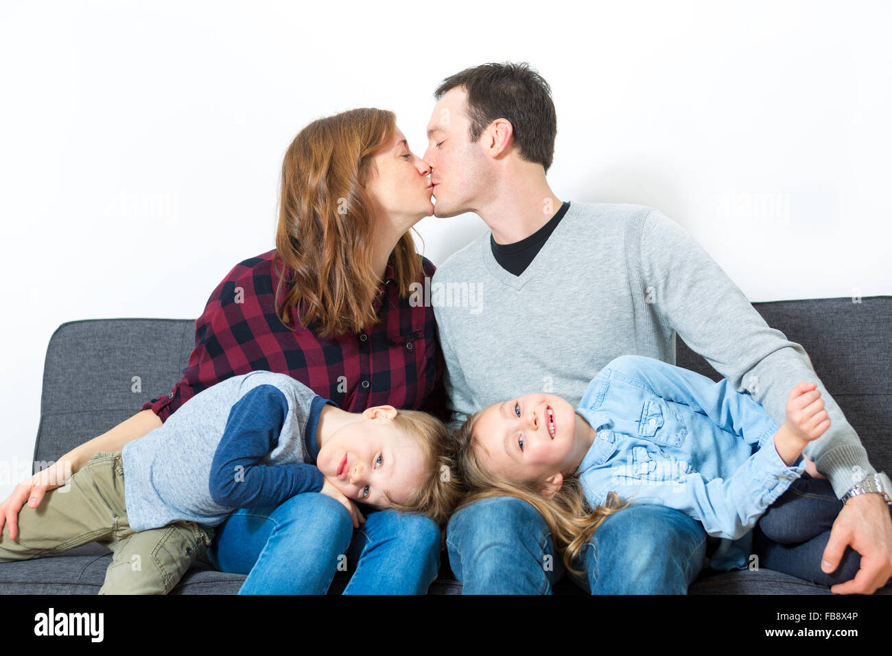 Nice family sit on the livingroom sofa Stock Photo - Alamy