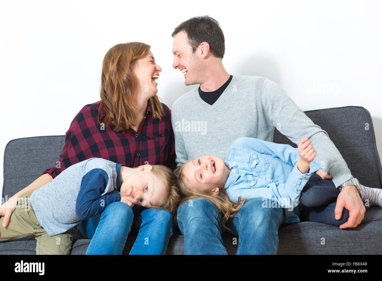 Nice family sit on the livingroom sofa Stock Photo - Alamy