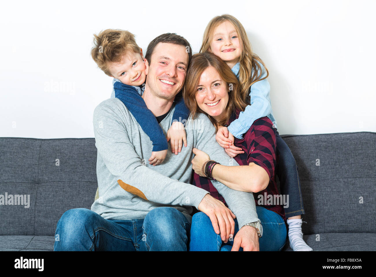 Nice family sit on the livingroom sofa Stock Photo - Alamy