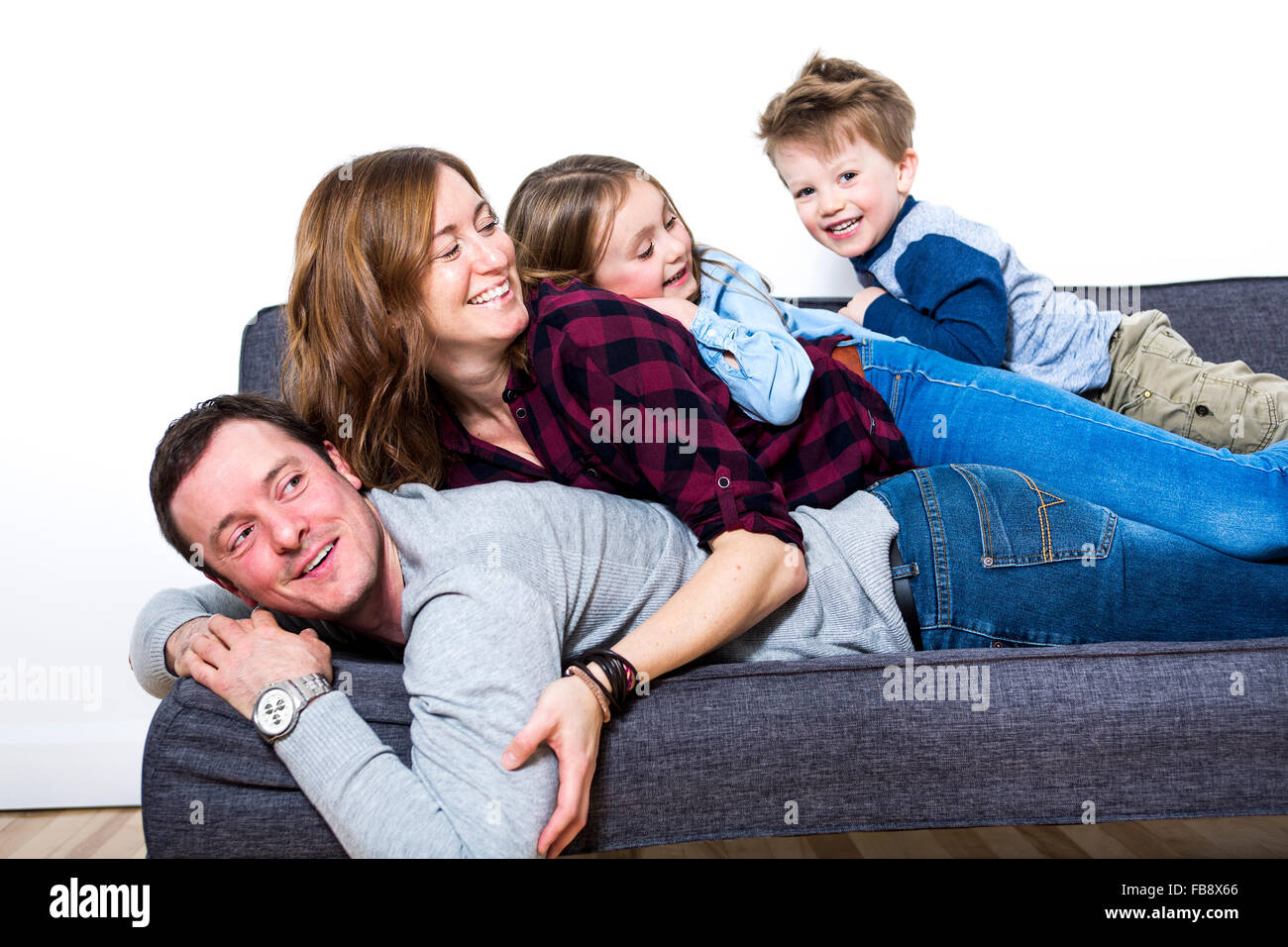 Nice family sit on the livingroom sofa Stock Photo - Alamy