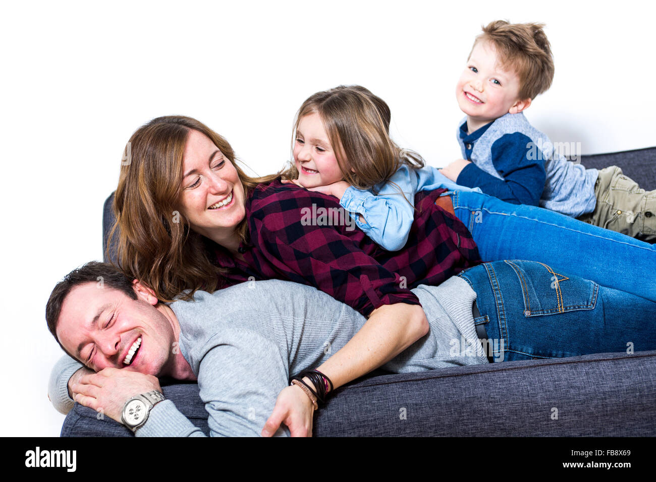 Nice family sit on the livingroom sofa Stock Photo - Alamy