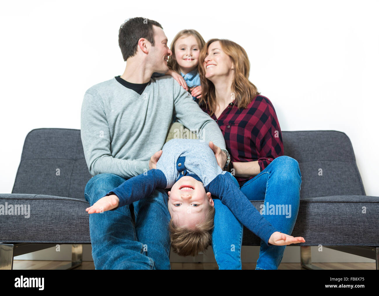 Nice family sit on the livingroom sofa Stock Photo - Alamy
