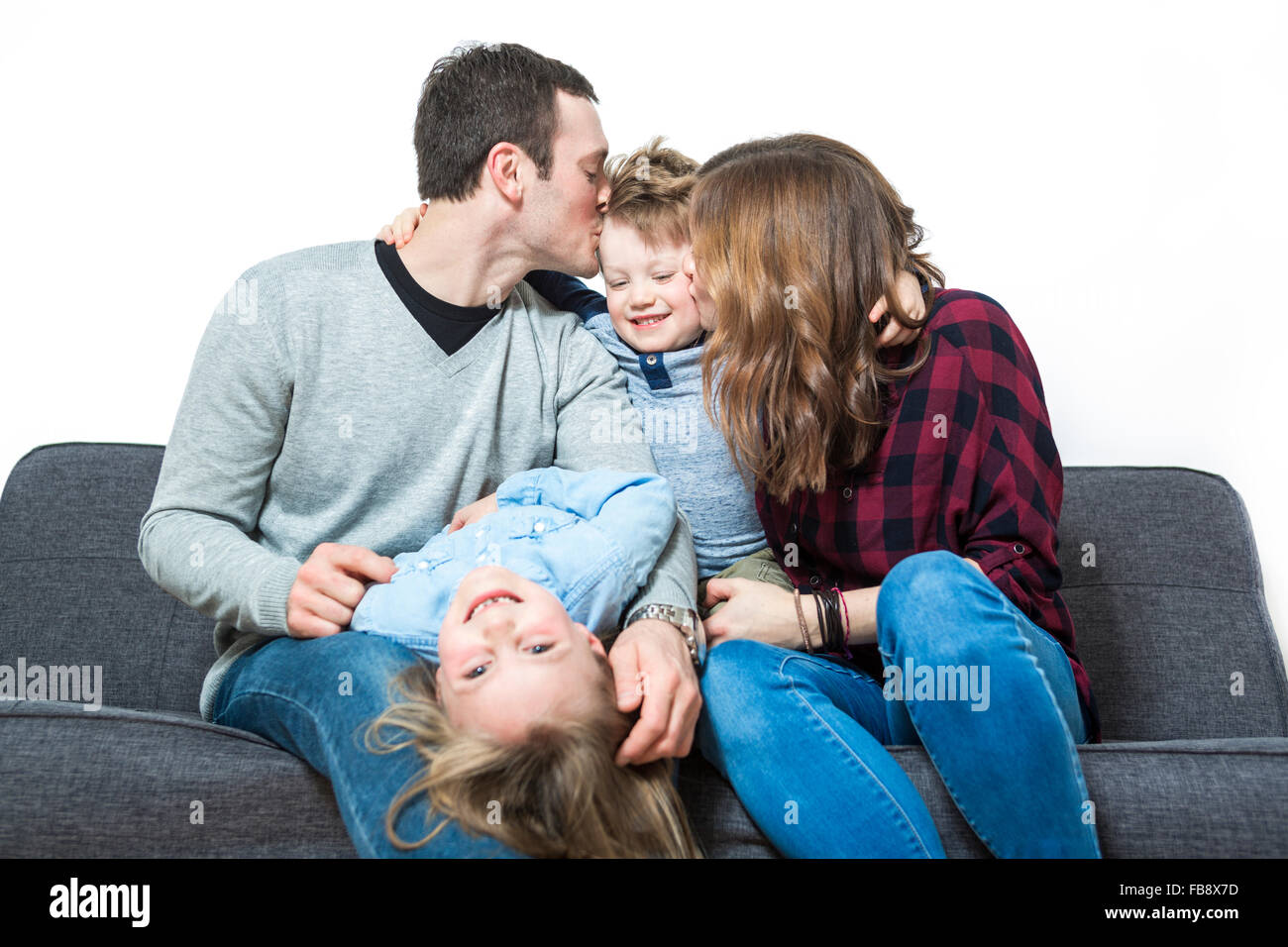Nice family sit on the livingroom sofa Stock Photo - Alamy