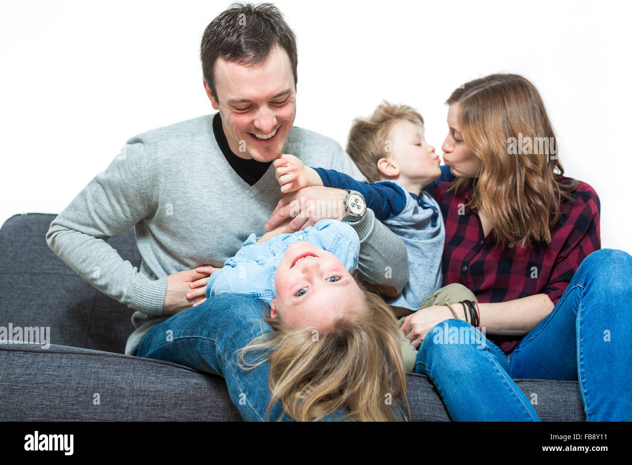 Nice family sit on the livingroom sofa Stock Photo - Alamy