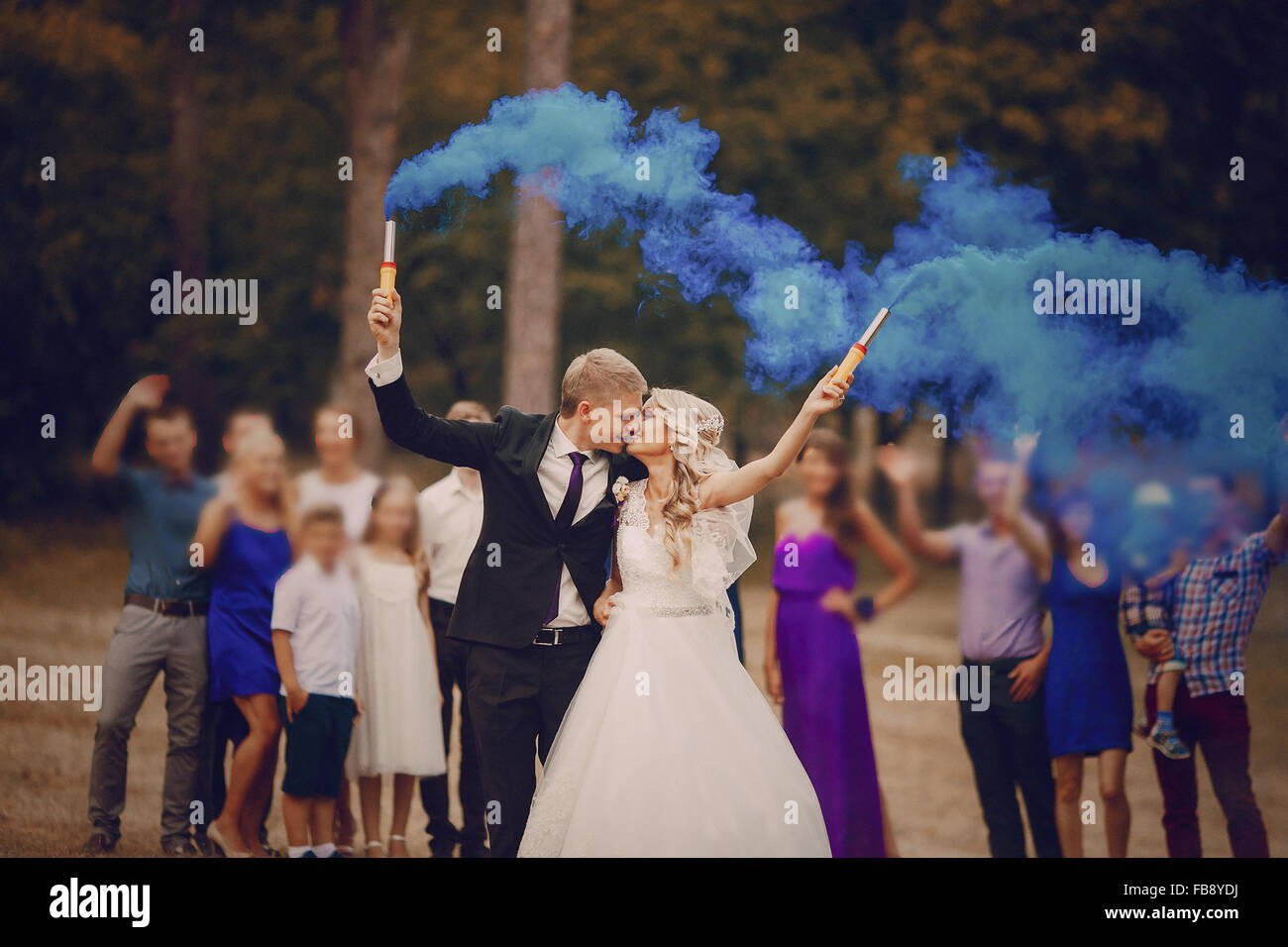 Wedding couple runs blue smoke Stock Photo - Alamy