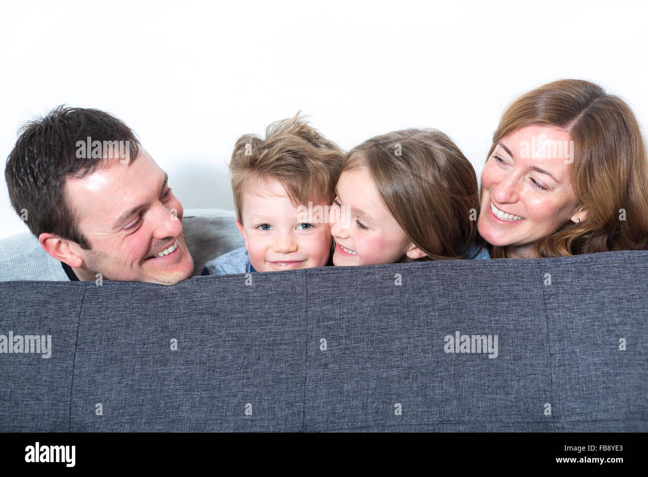Nice family sit on the livingroom sofa Stock Photo - Alamy