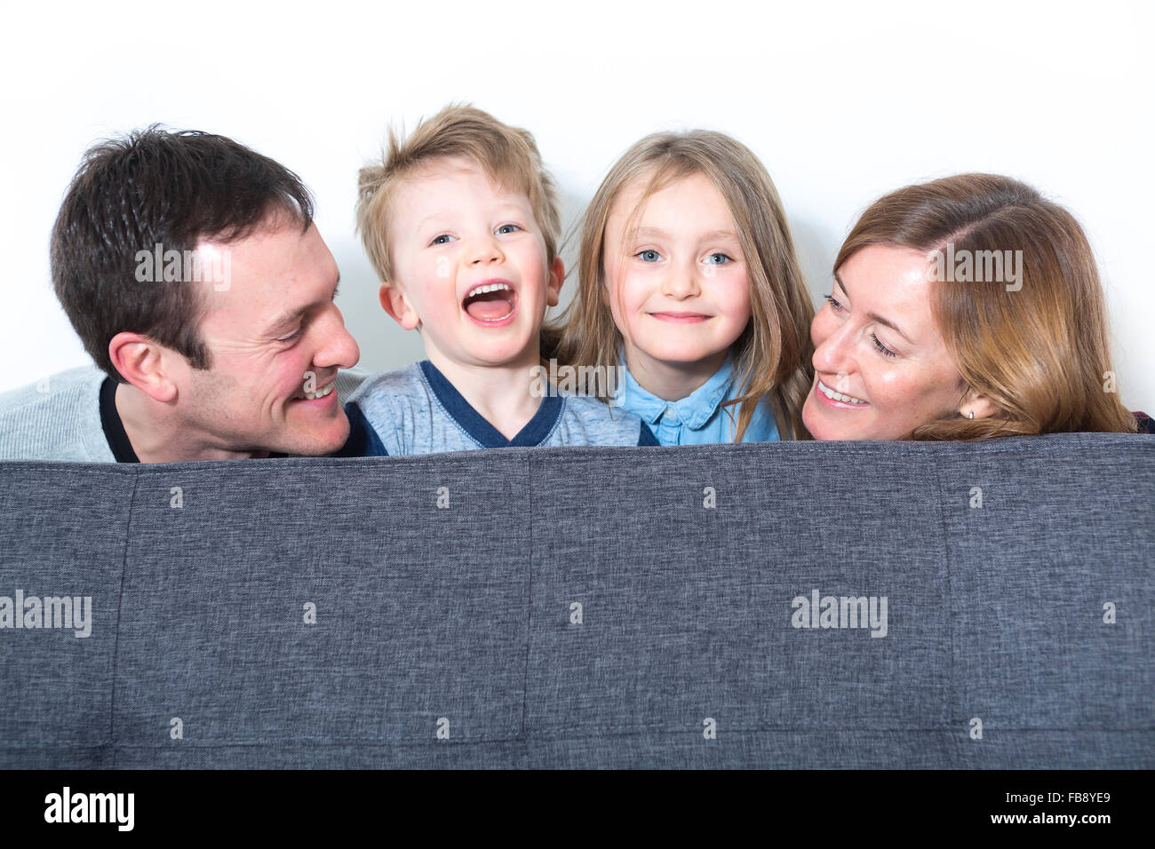 Nice family sit on the livingroom sofa Stock Photo - Alamy