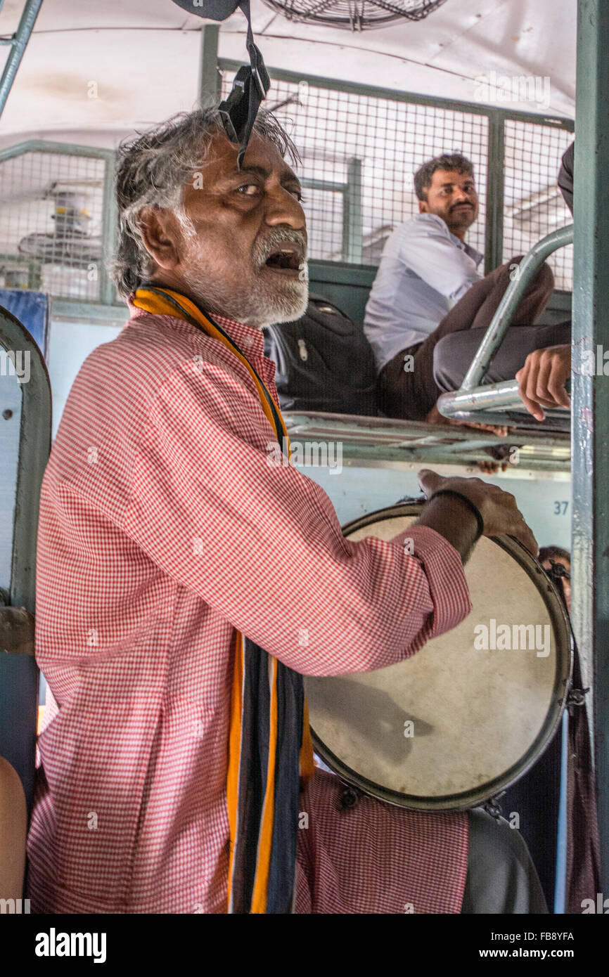Traveling musician playing for passengers on an Indian train Stock ...