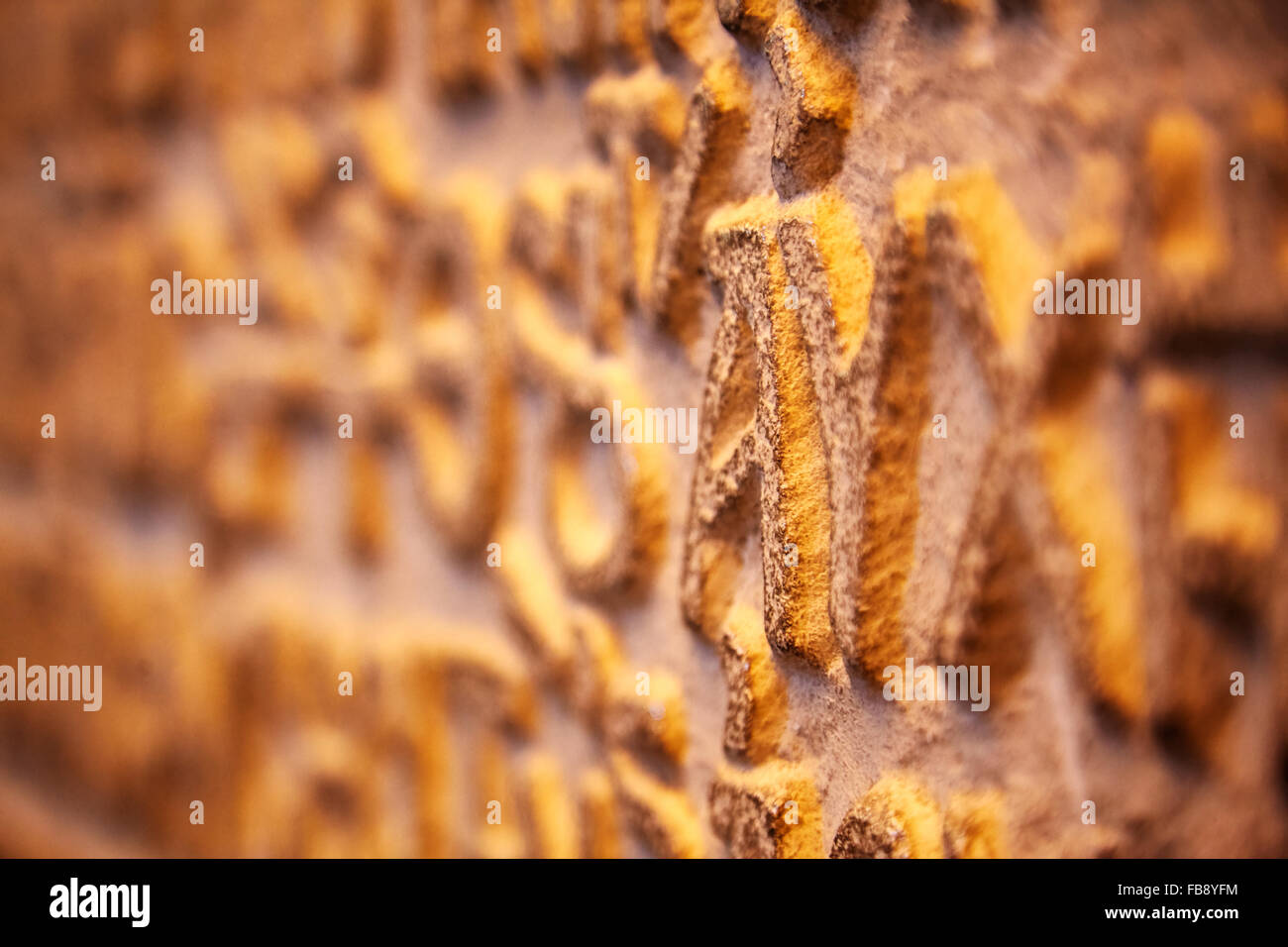 Close-up shot of Greek letters in perspective on a stucco copy of ...