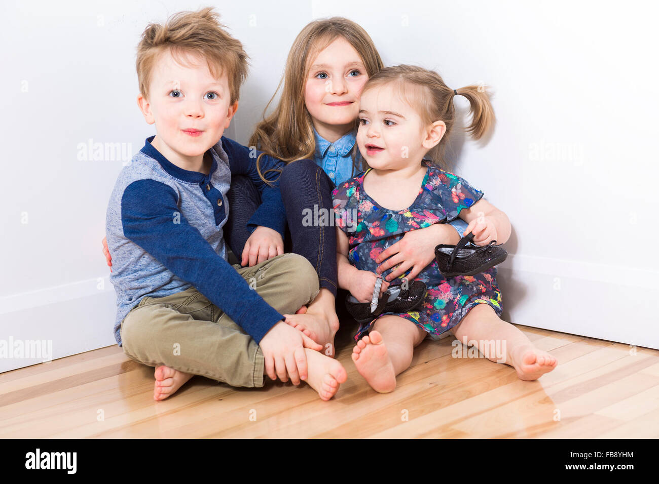 three child sit on the floor at home Stock Photo - Alamy