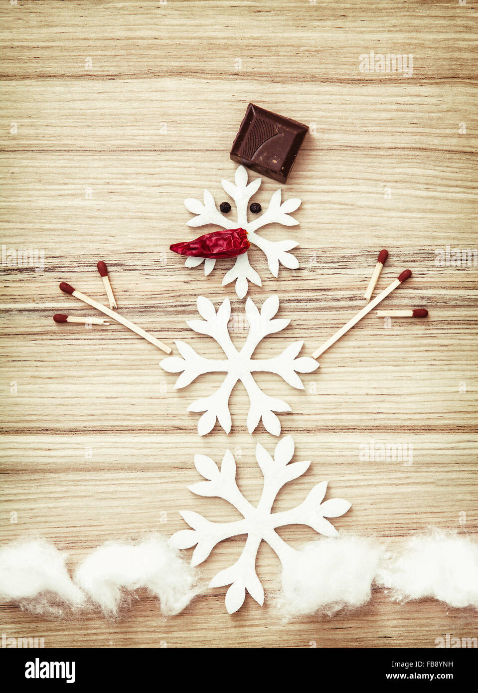 Beautiful snowman made of snow flakes, matches, chocolate and chili ...