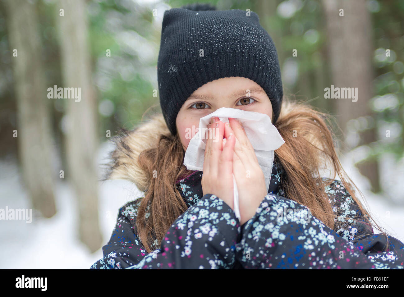 child with tissue outside in forest winter season Stock Photo - Alamy