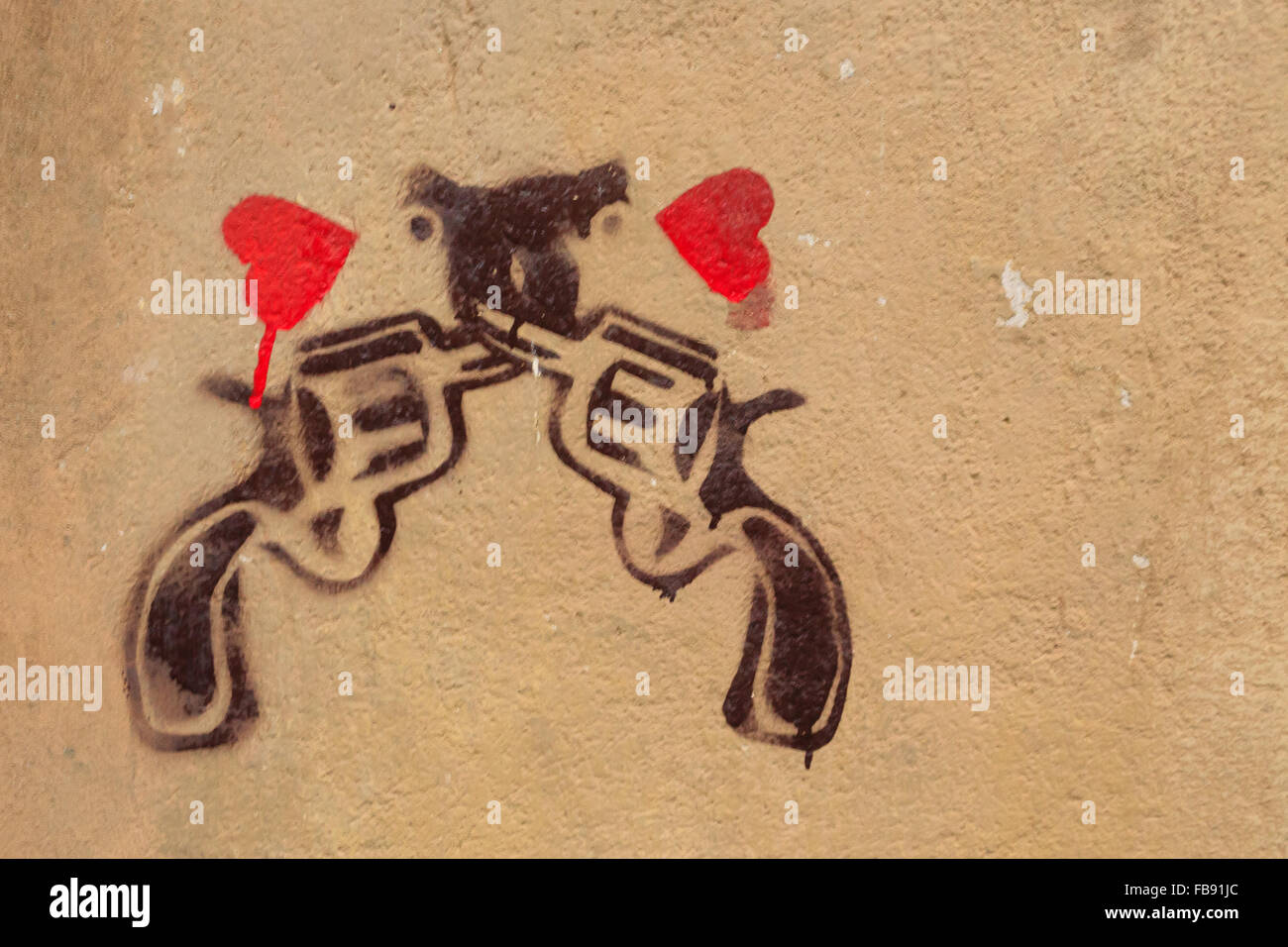 Street art, two crossed pistols with hearts, graffiti Stock Photo - Alamy