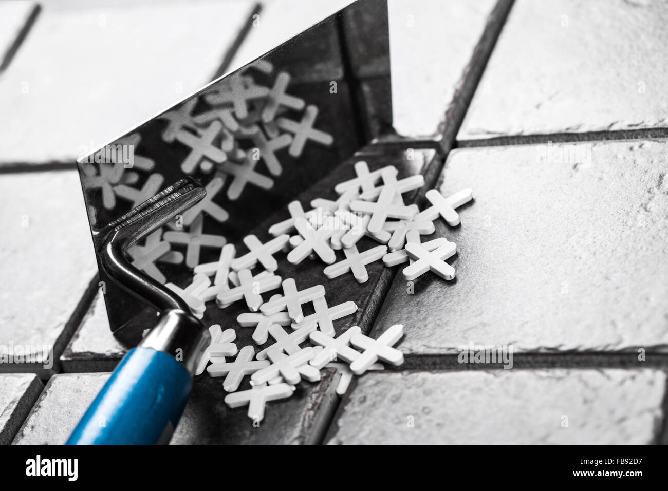 the trowel closeup on a background of ceramic tile Stock Photo - Alamy