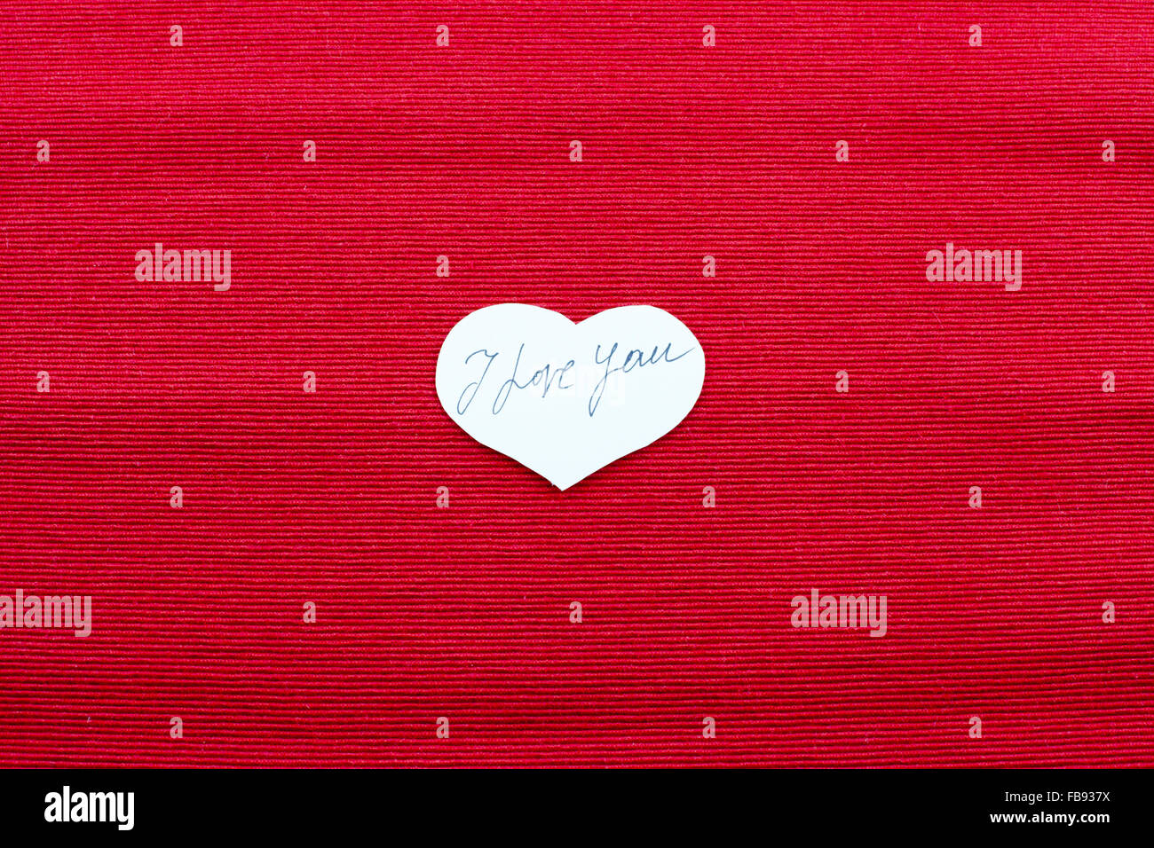 I Love you note inside a white paper heart on red cloth Stock Photo - Alamy