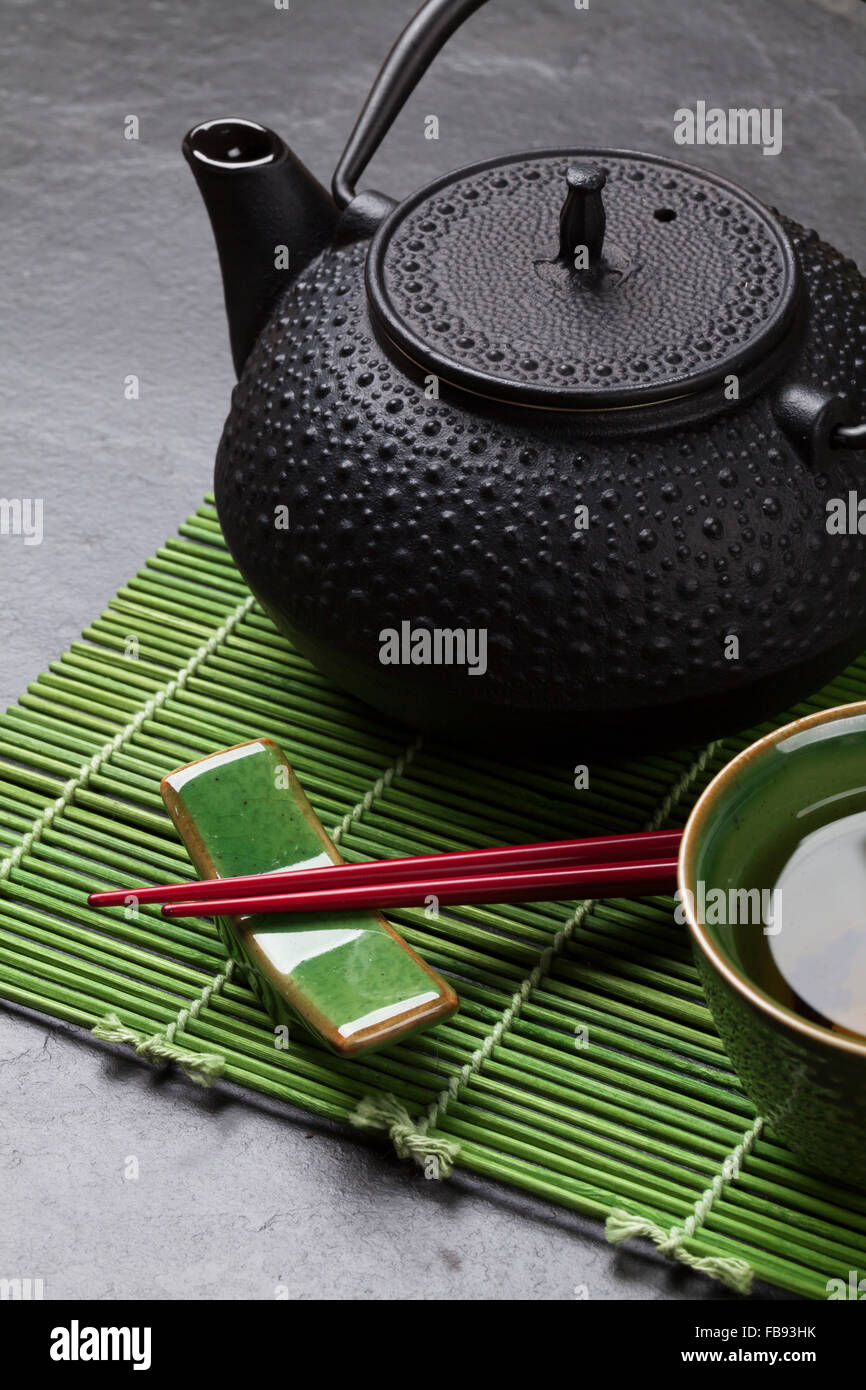 Asian tea and teapot over stone table Stock Photo - Alamy