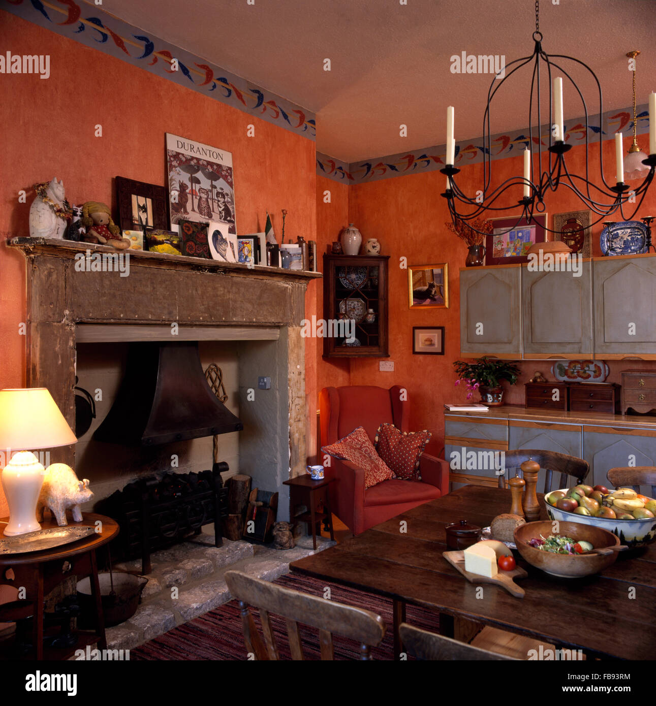 Stone fireplace in terracotta colored kitchen dining room with a simple ...