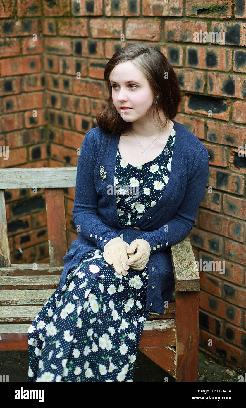 Woman sitting on a bench outdoor Stock Photo - Alamy