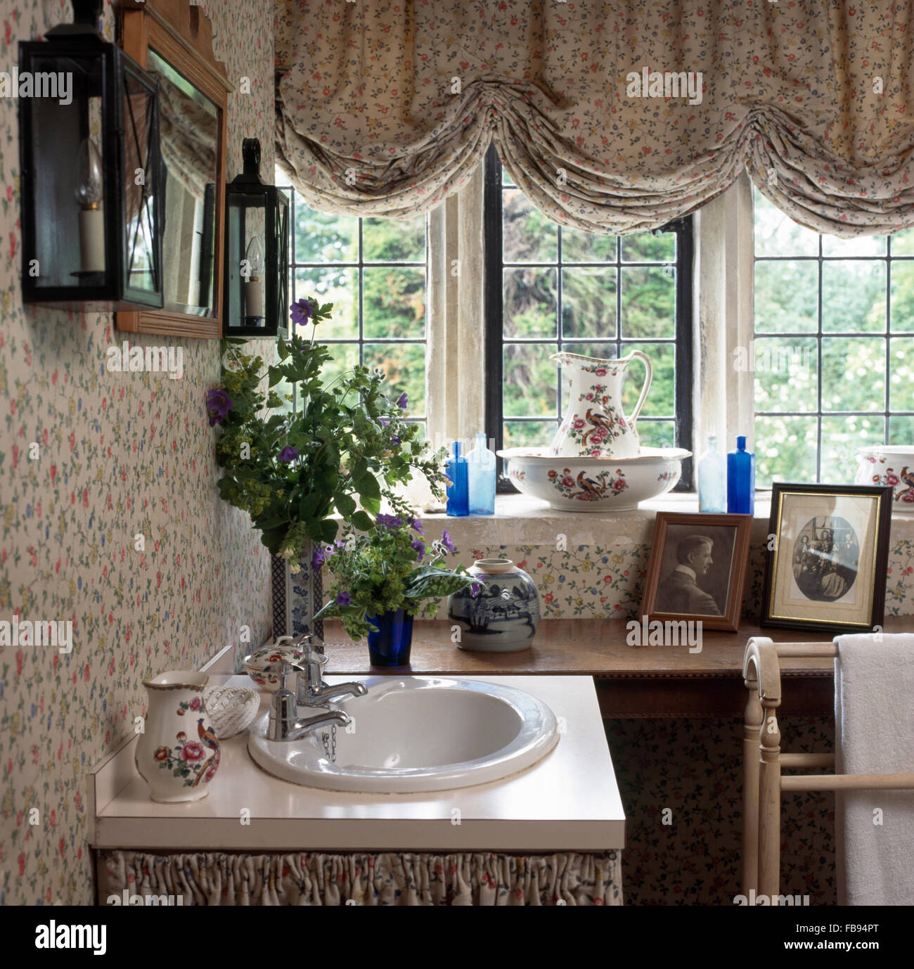 Festoon blind on window in nineties bathroom with patterned wallpaper ...