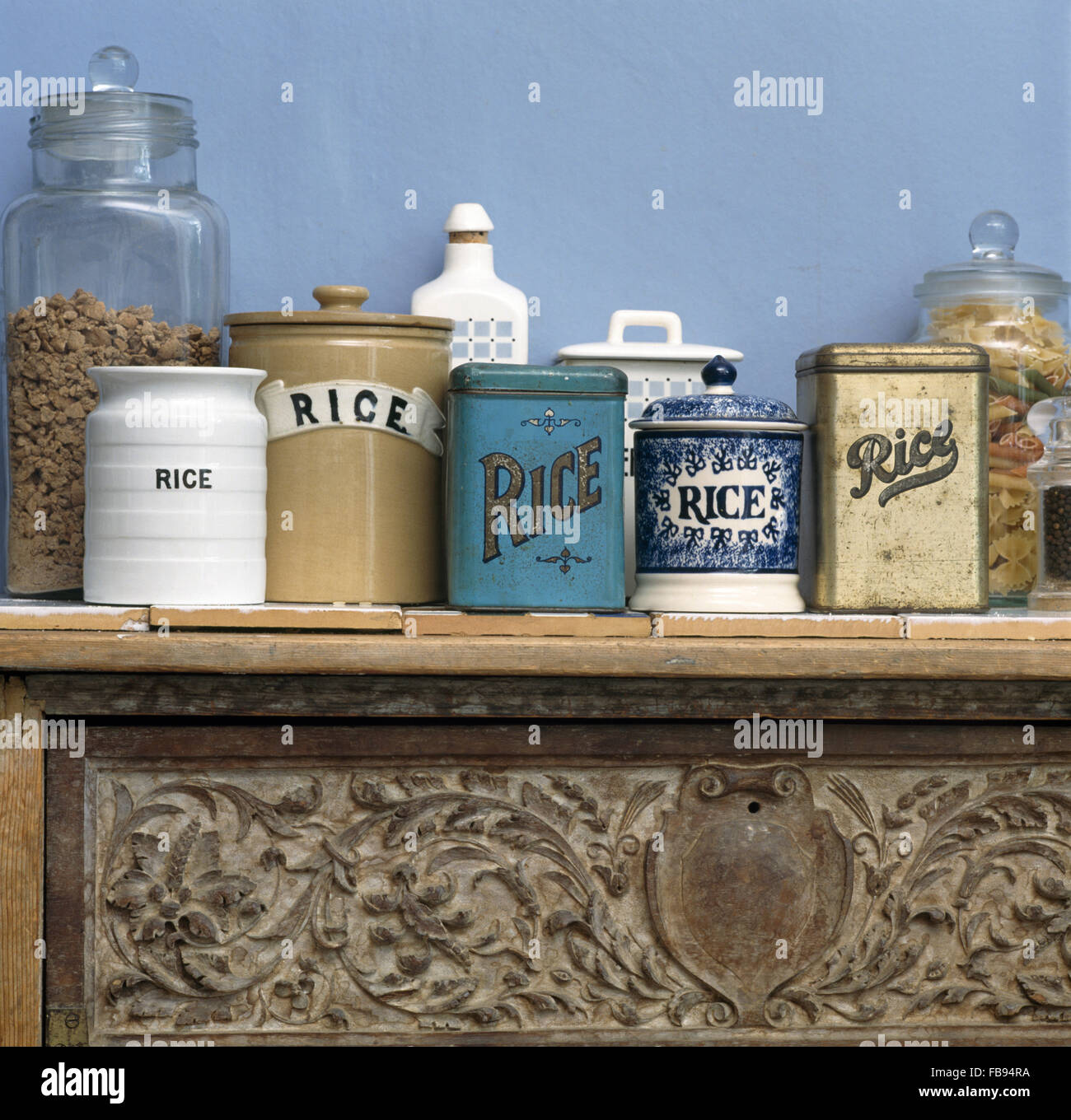 Collection of vintage rice storage tins and jars on shelf Stock Photo ...