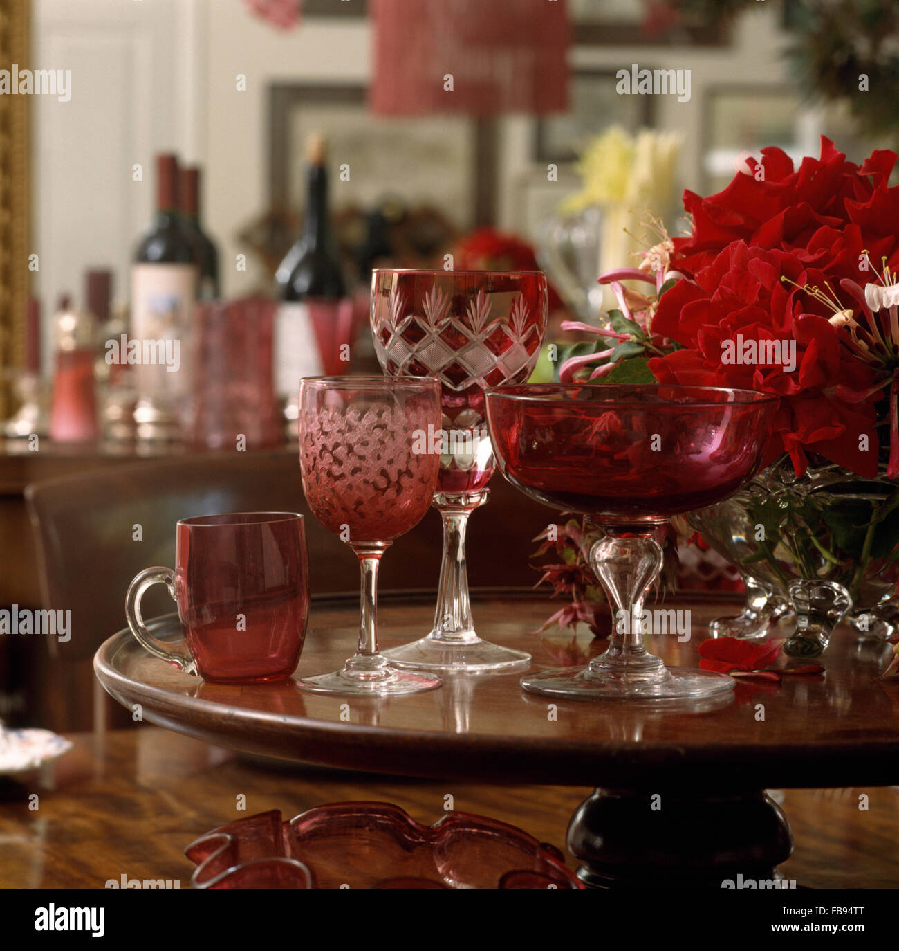 Collection of antique cranberry glass on a small table Stock Photo - Alamy