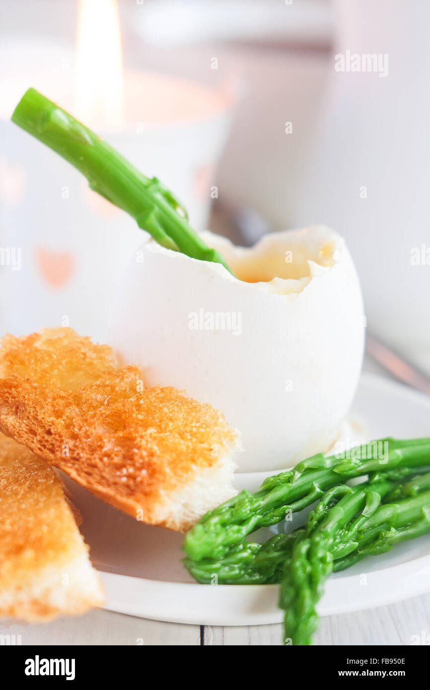 Soft boiled eggs with asparagus and toast soldiers Stock Photo - Alamy
