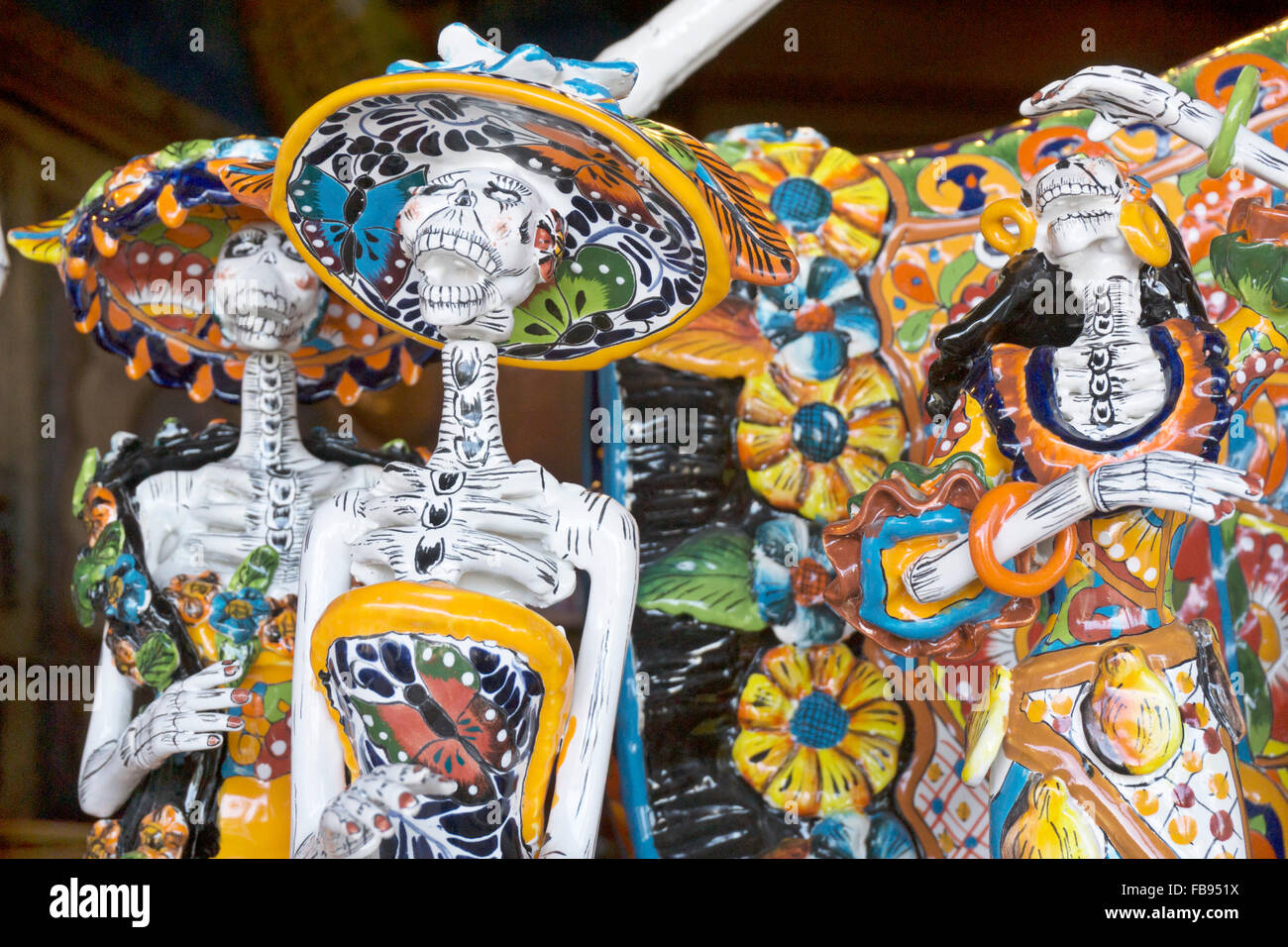 lurid glazed ceramic Day of the Dead white female skeletons wearing ...