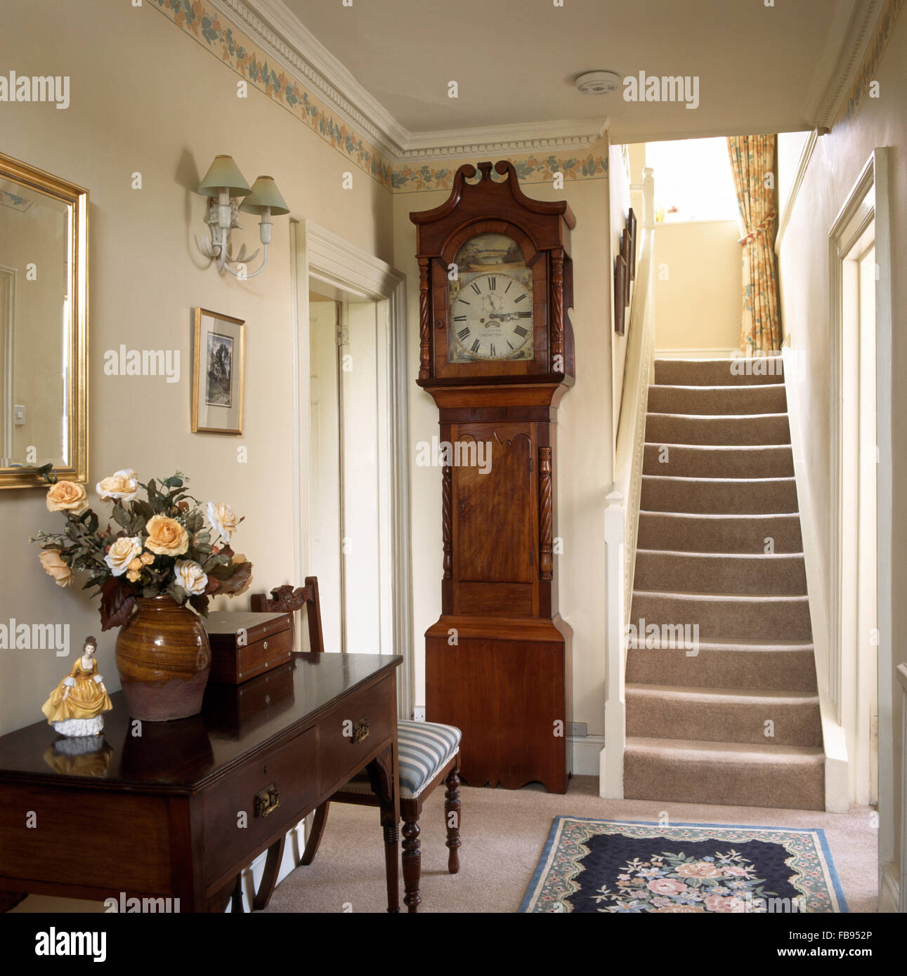 Antique long case clock in country hall with an antique console table ...