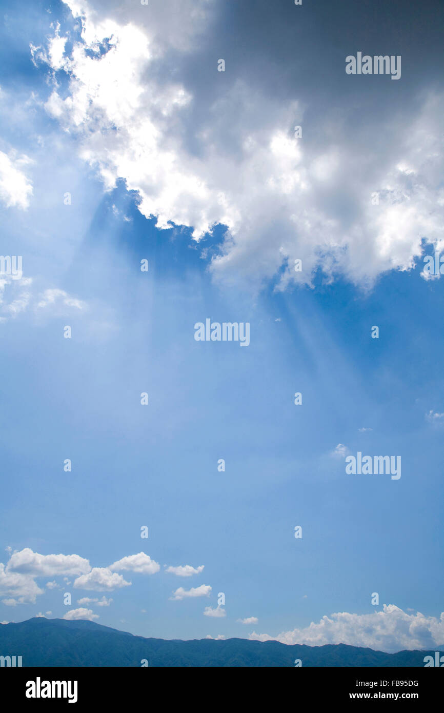 Sun beaming from behind clouds Stock Photo - Alamy