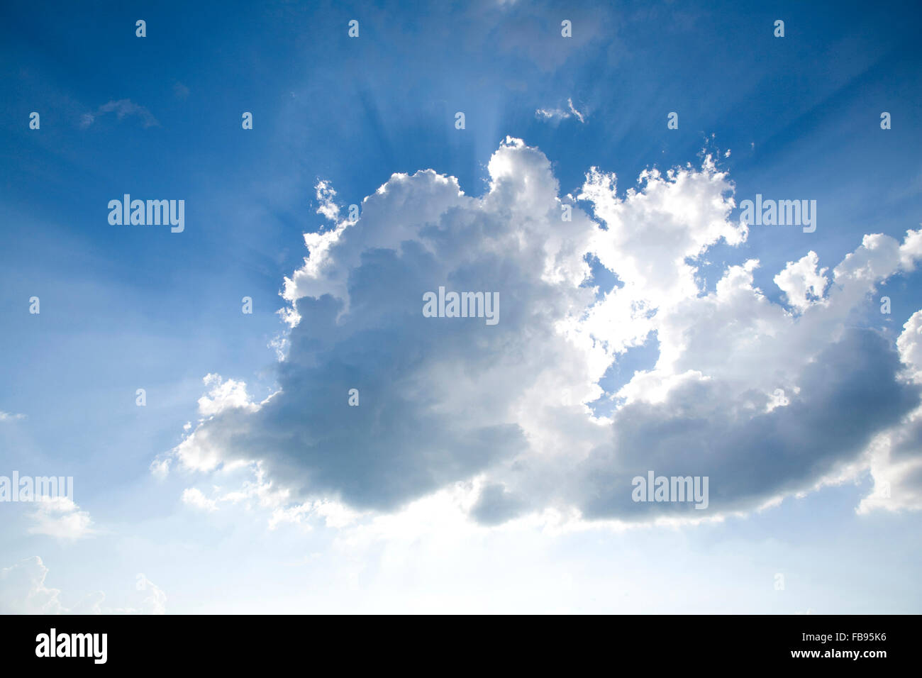 Sun beaming from behind clouds Stock Photo - Alamy