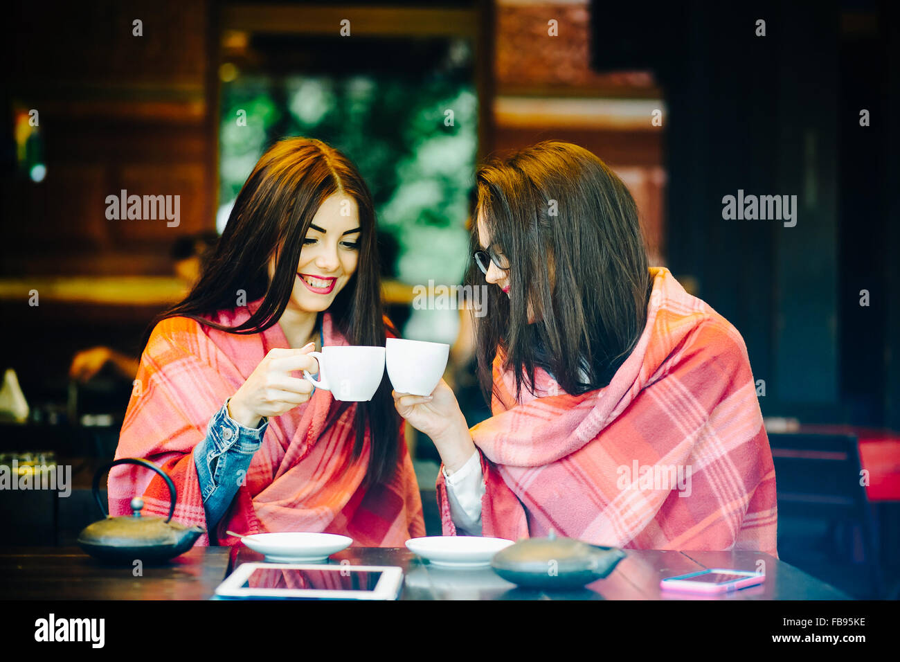 Two young and beautiful girls gossiping Stock Photo - Alamy